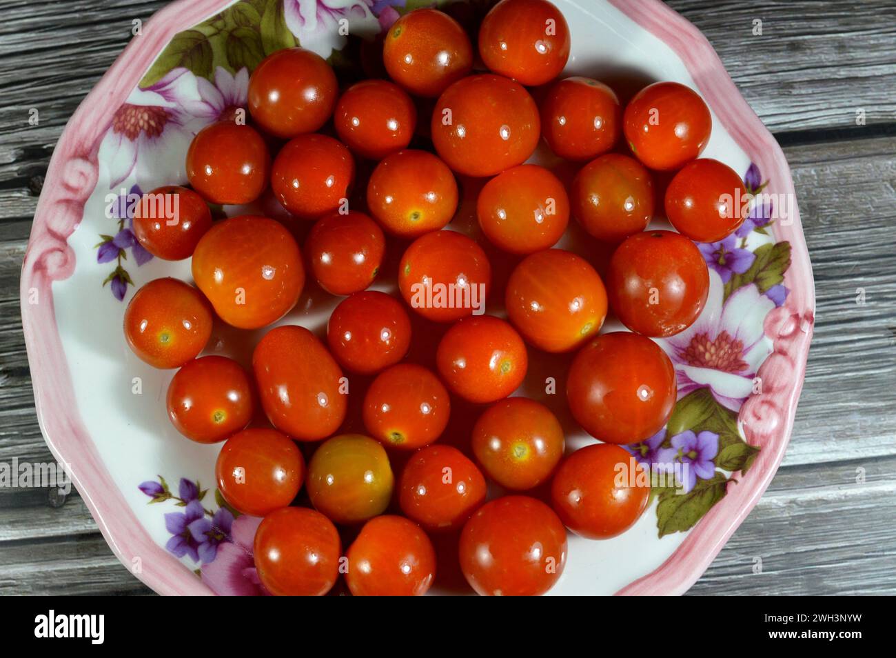 The cherry tomato, a type of small round tomato believed to be an ...