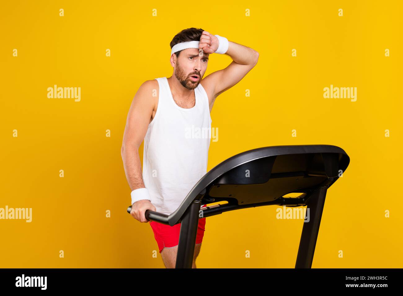 Portrait of exhausted person wipe sweat forehead intense run treadmill ...