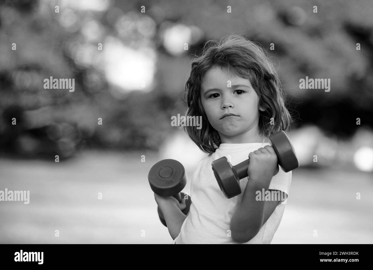 Fitness dumbbells kid exercise workout outdoor. Boy sporty child with ...