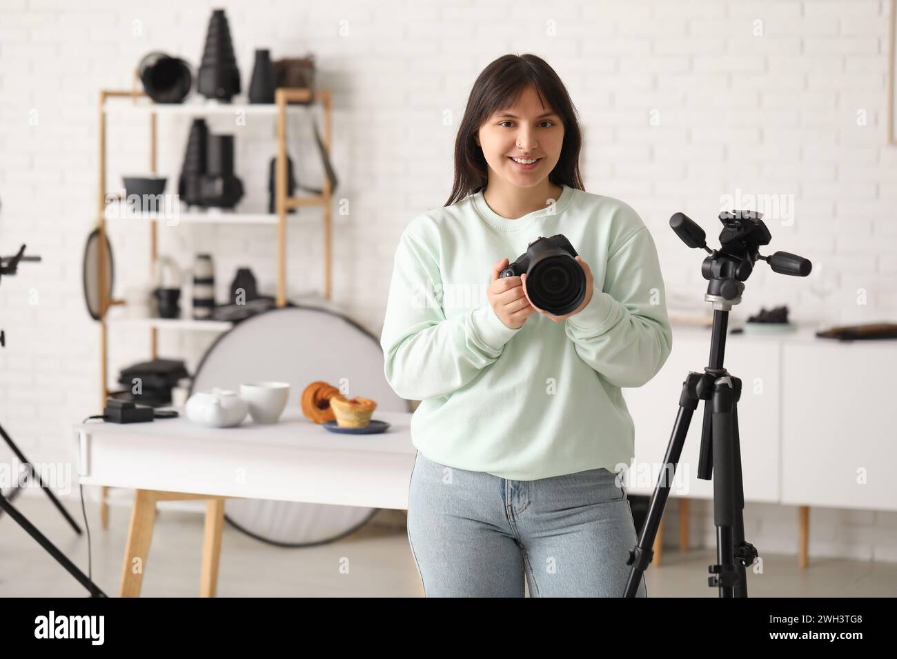 Female food photographer with camera in studio Stock Photo - Alamy