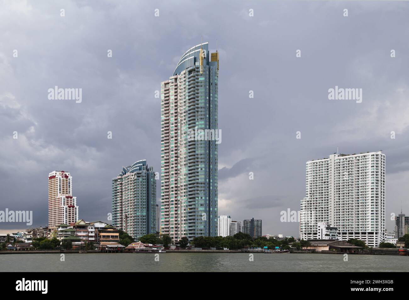 Modern condominiums and other buildings alongside the Chao Phraya river ...