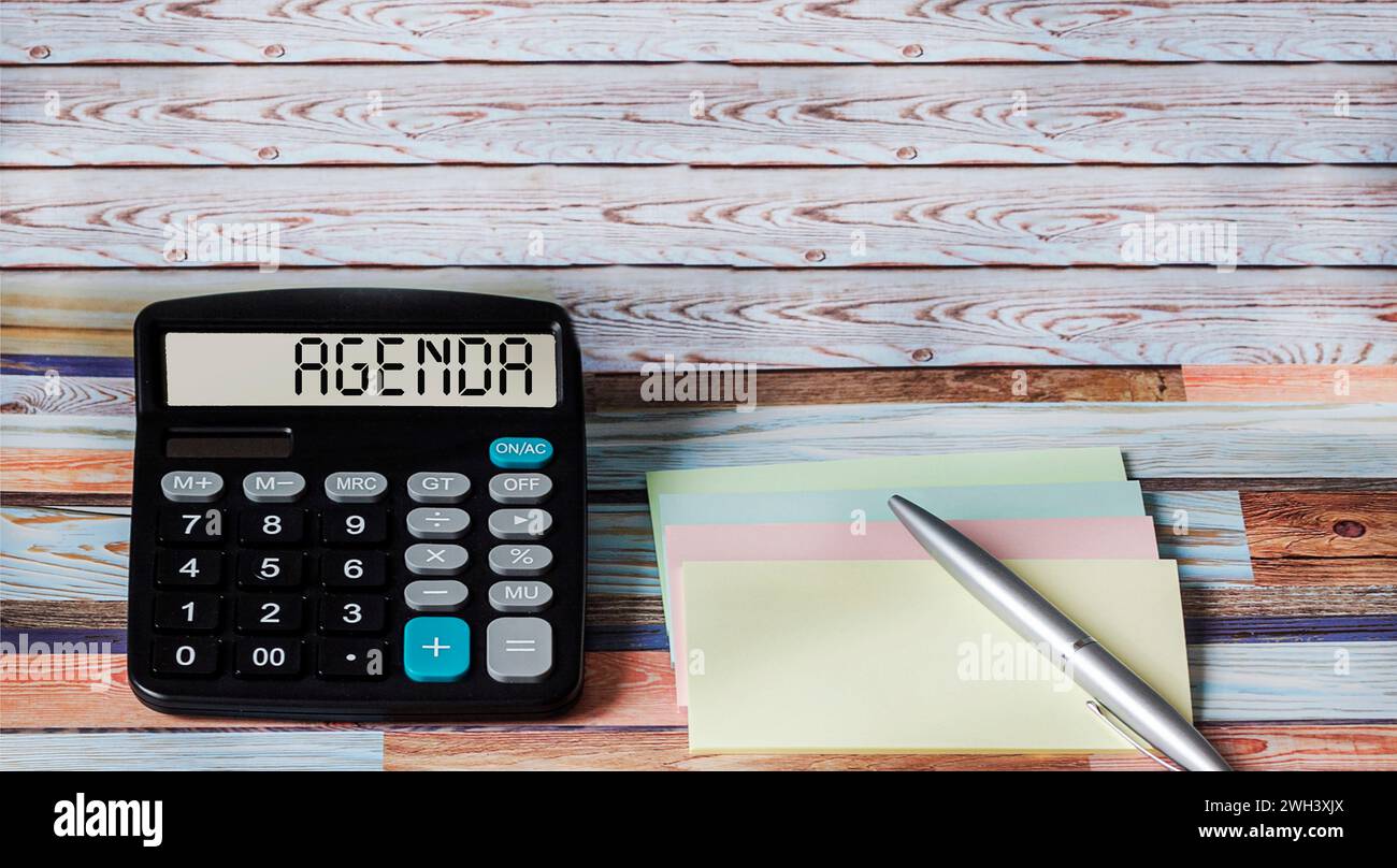 Agenda symbol. Calculator with the word Agenda concept on a beautiful ...
