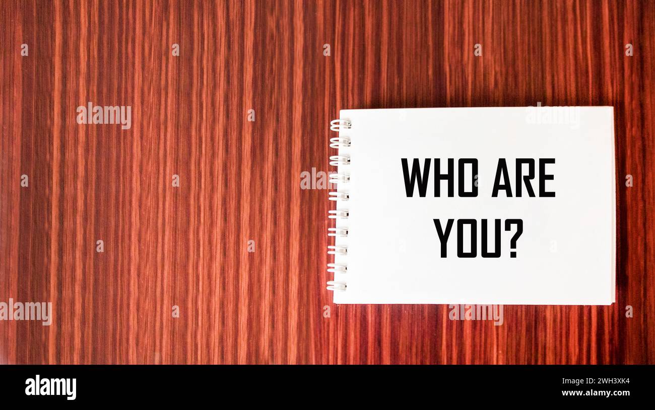 Who are you question written on a notepad and wooden background Stock ...