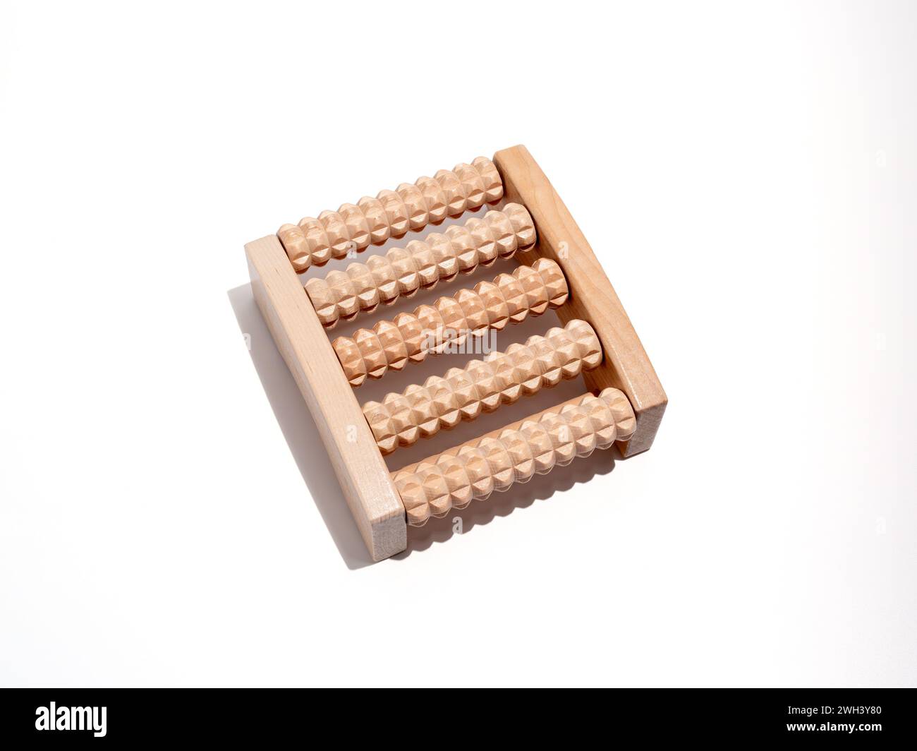 Wooden foot massager on a white background. Wooden massager close-up ...