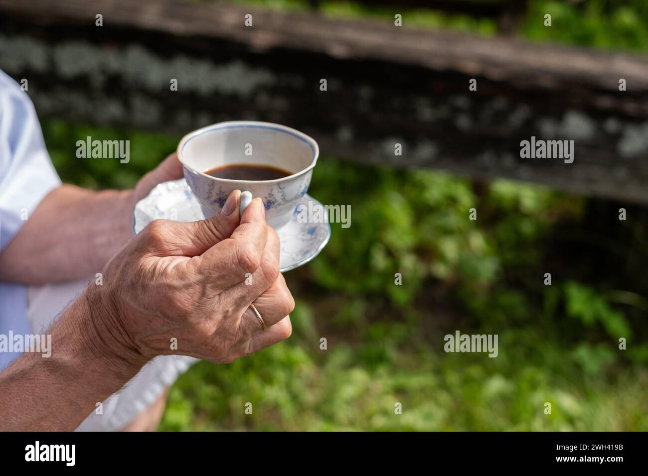 Elderly man sipping tea, with a focus on relaxation and the simplicity ...