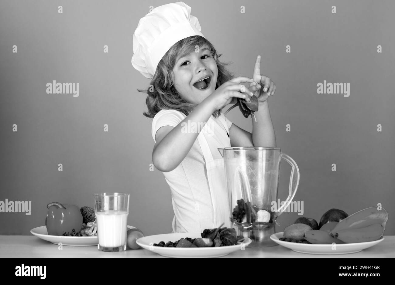 Child chef isolated on blue. Funny little kid chef cook wearing uniform ...