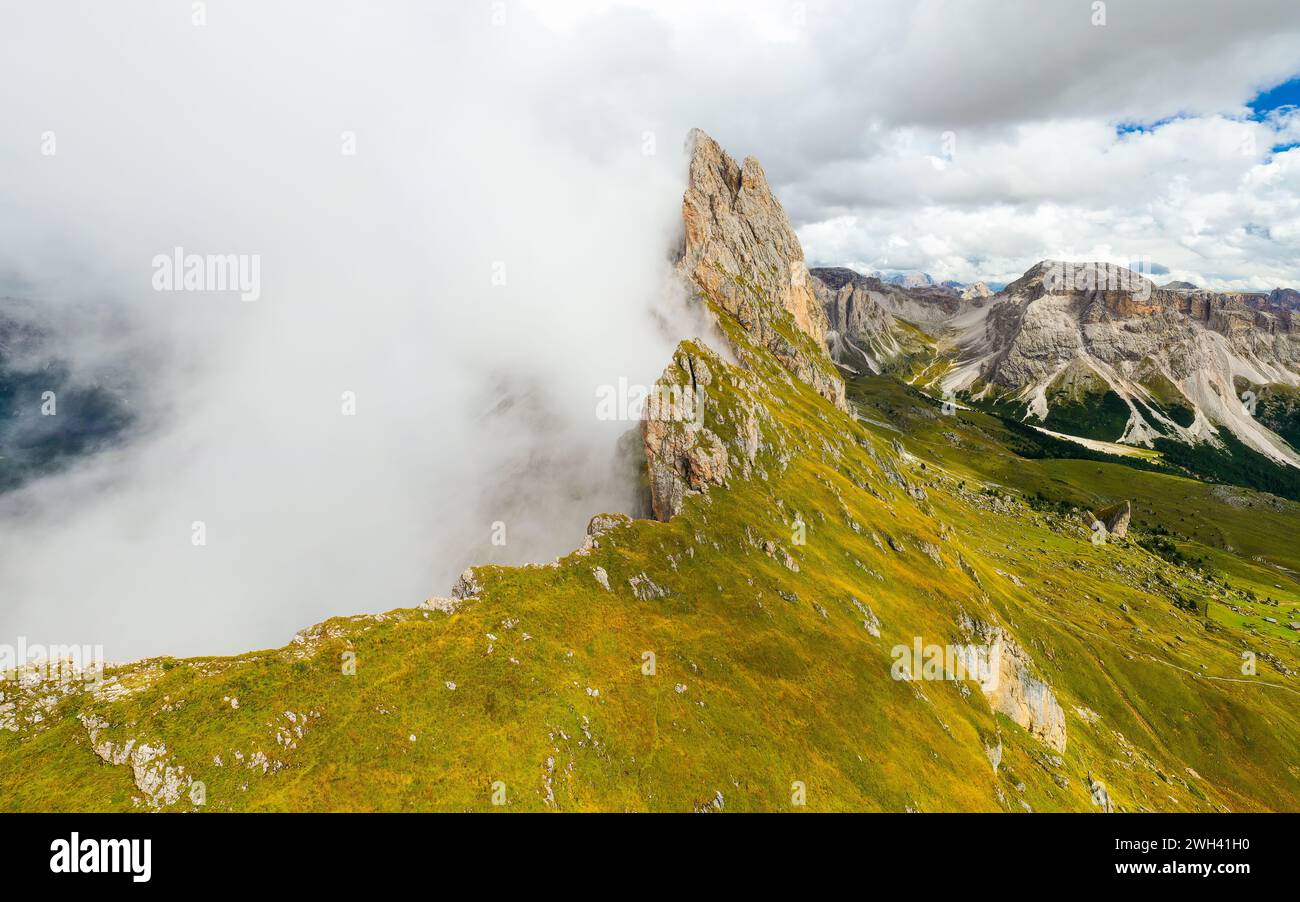 Observation point facing Seceda mountain surrounded by white dense fog ...