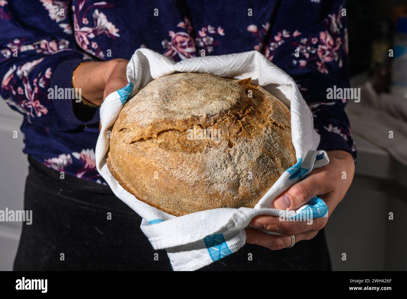 Woman holding homemade whole grain bread in her hands 2 Stock Photo - Alamy