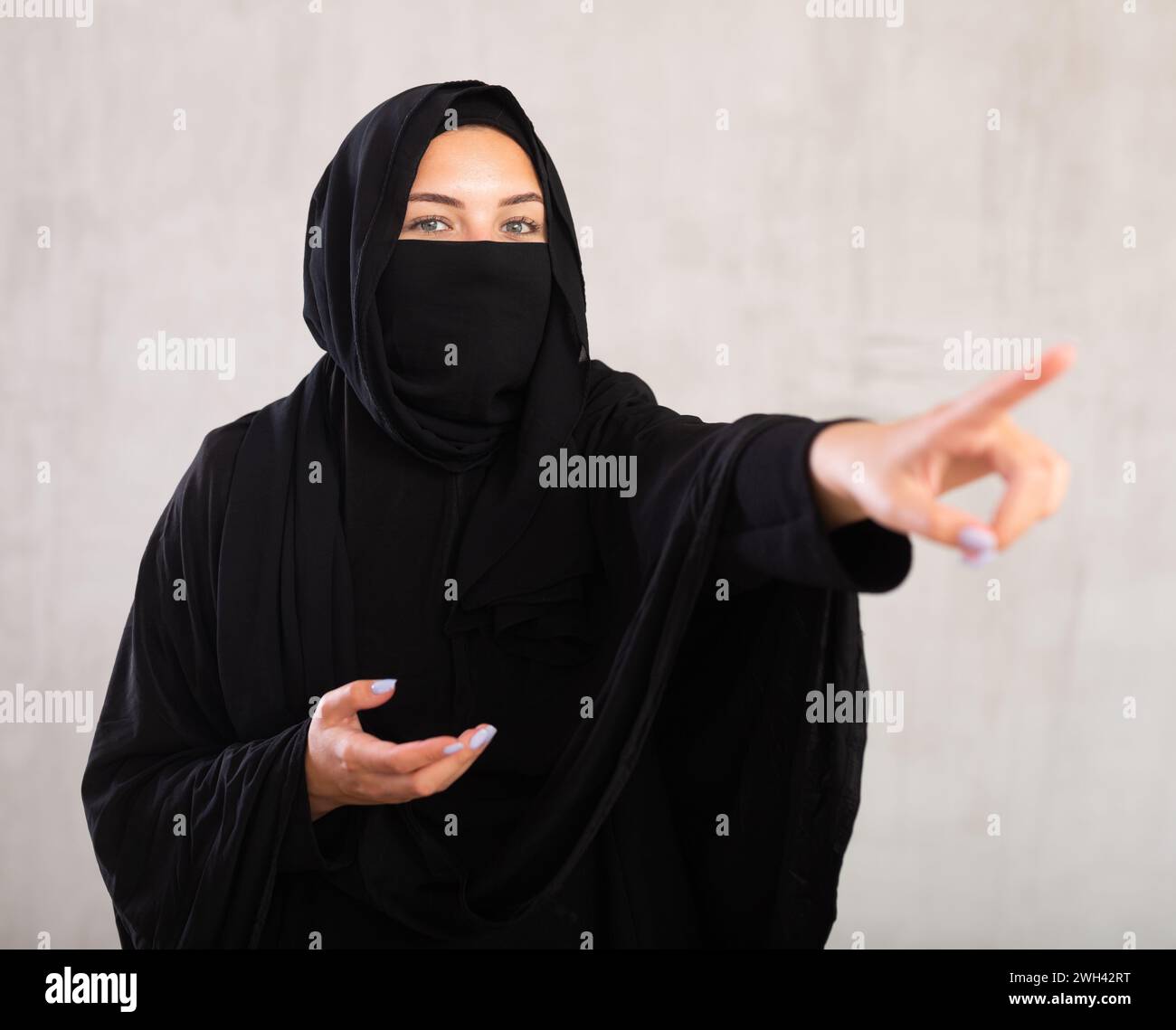 woman with her face covered by burka points her hand to side Stock ...