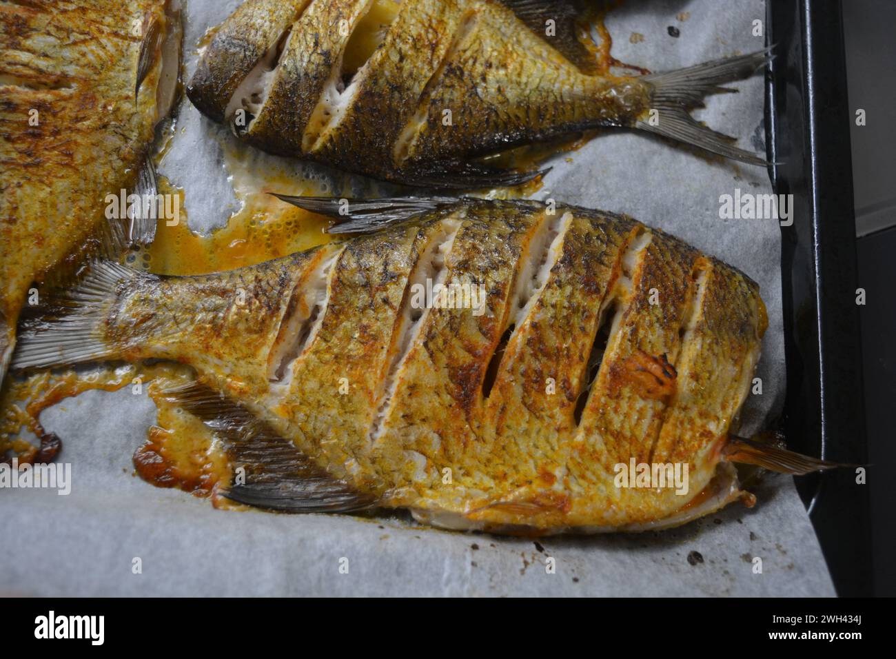 Delicious and healthy, baked fish, Carassius with lemon on a black ...