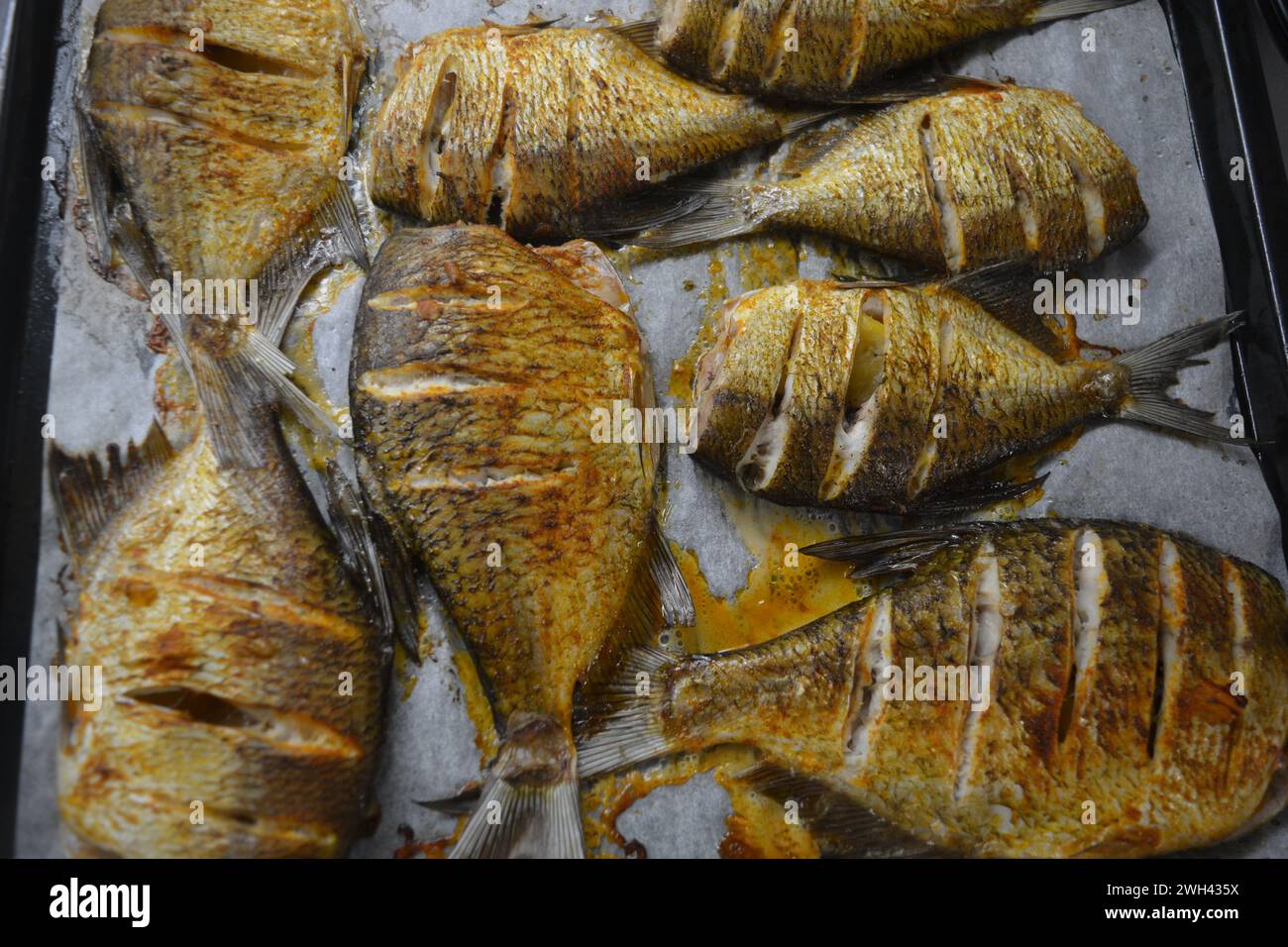 Delicious and healthy, baked fish, Carassius with lemon on a black ...