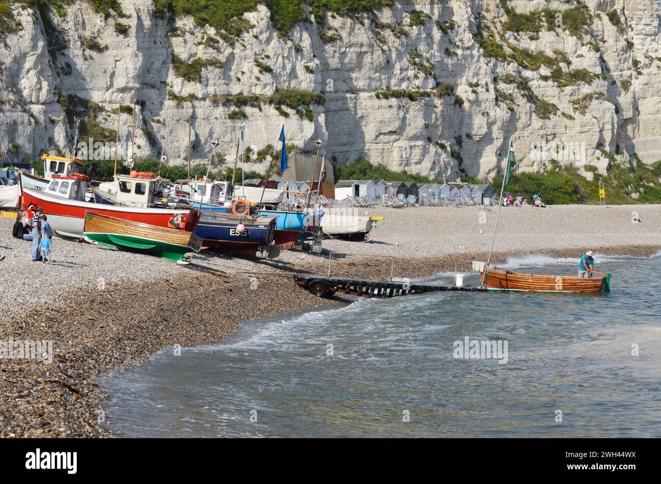 boats, tourists, cliffs, beach at beer devon england Stock Photo - Alamy