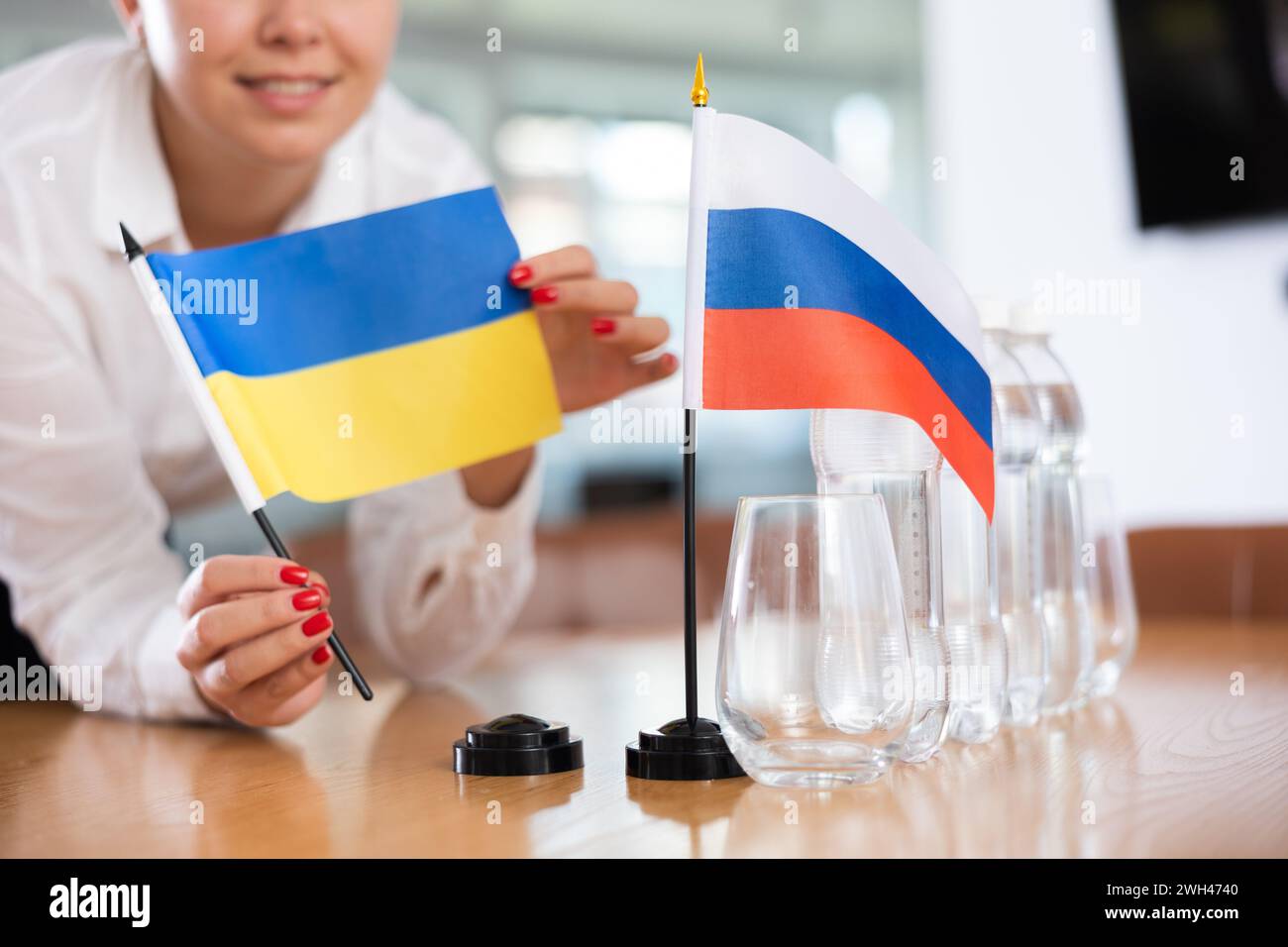 Flags of Ukraine and Russia stand on negotiating table in office Stock ...