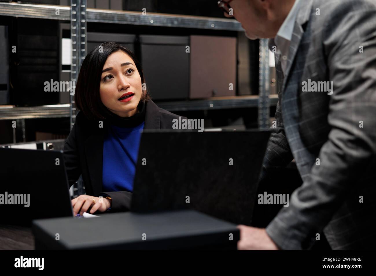 Professional administration employees imputing bookkeeping administrative data paperwork on ...