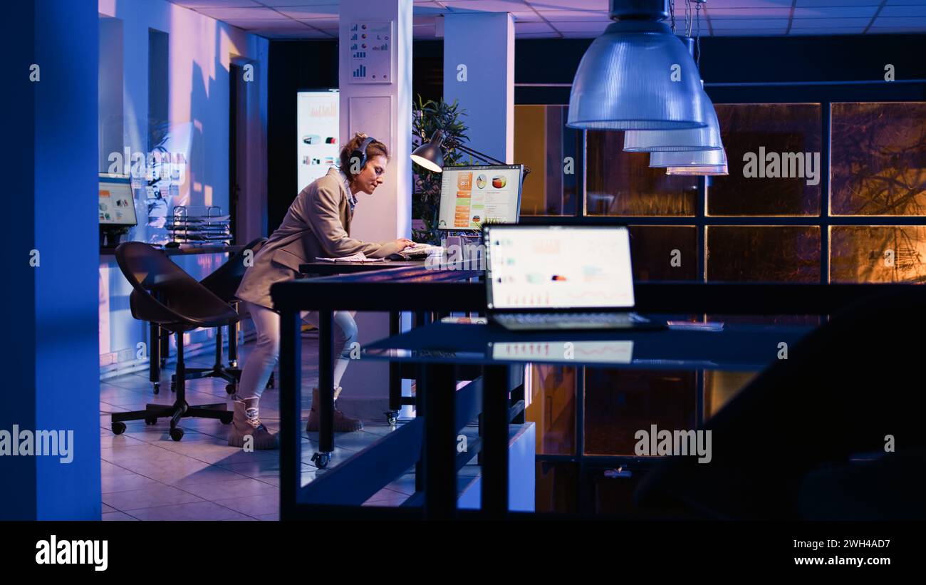Happy employee analyzing graphs wearing hi-res stock photography and ...