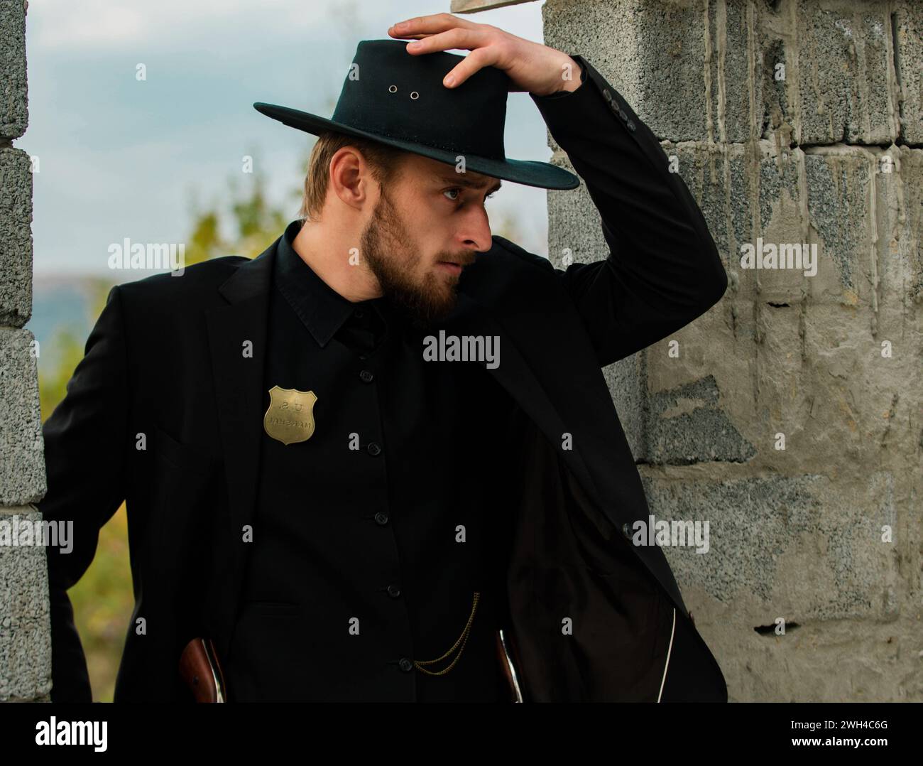 Sheriff or cowboy in black suit and cowboy hat. Man with west vintage ...