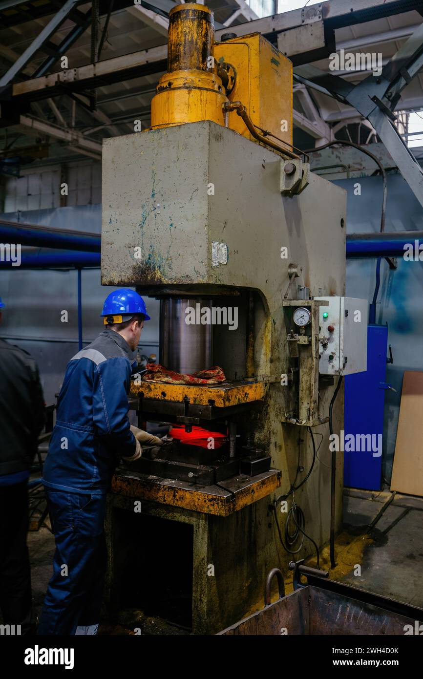 Process of pressing and quenching of hot iron part Stock Photo - Alamy