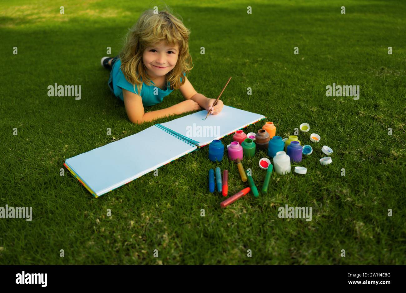 Kids painting with paints color and brush in park outdoor. Happy child ...