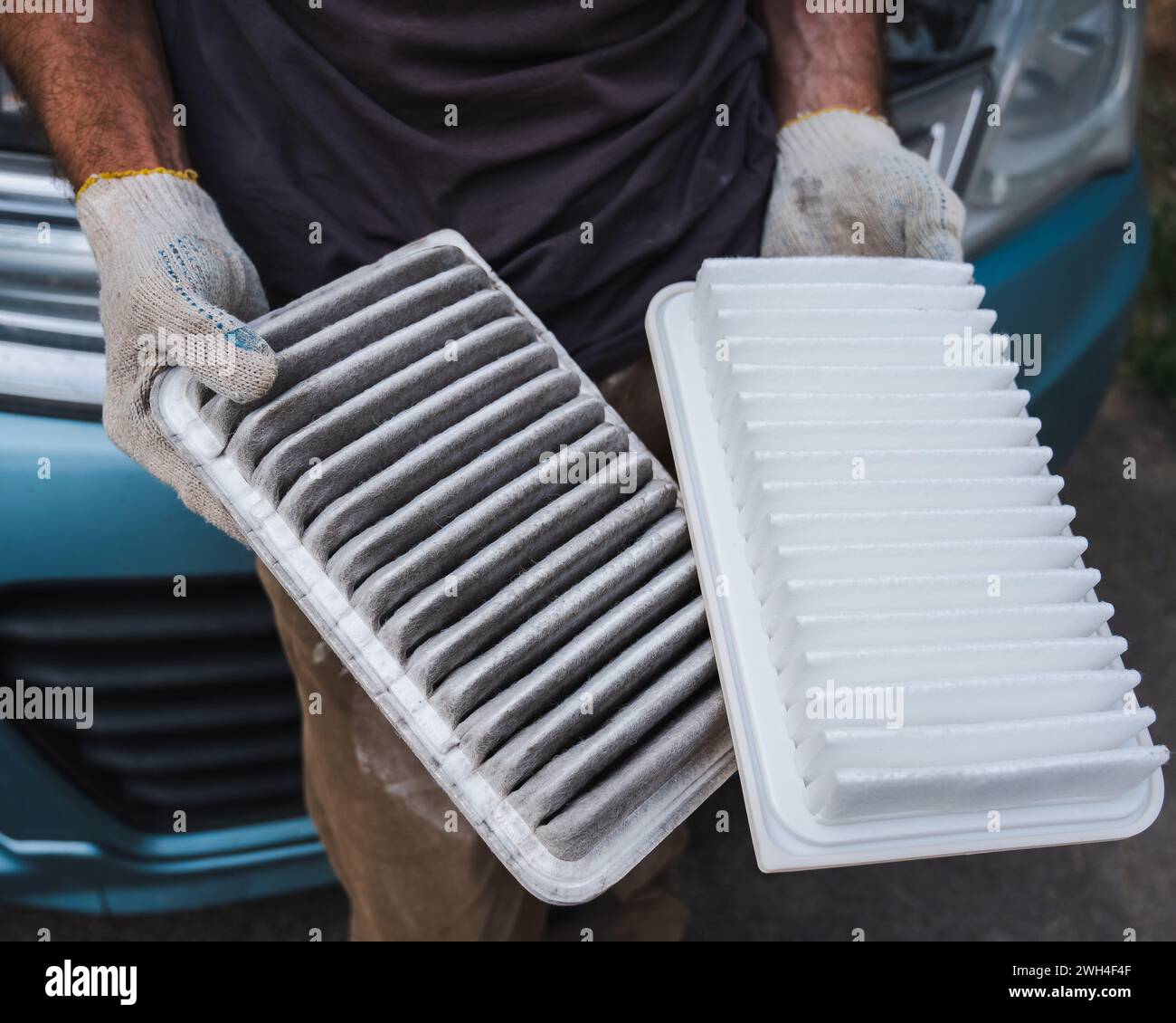 The master changes the air filter in the car engine Stock Photo - Alamy