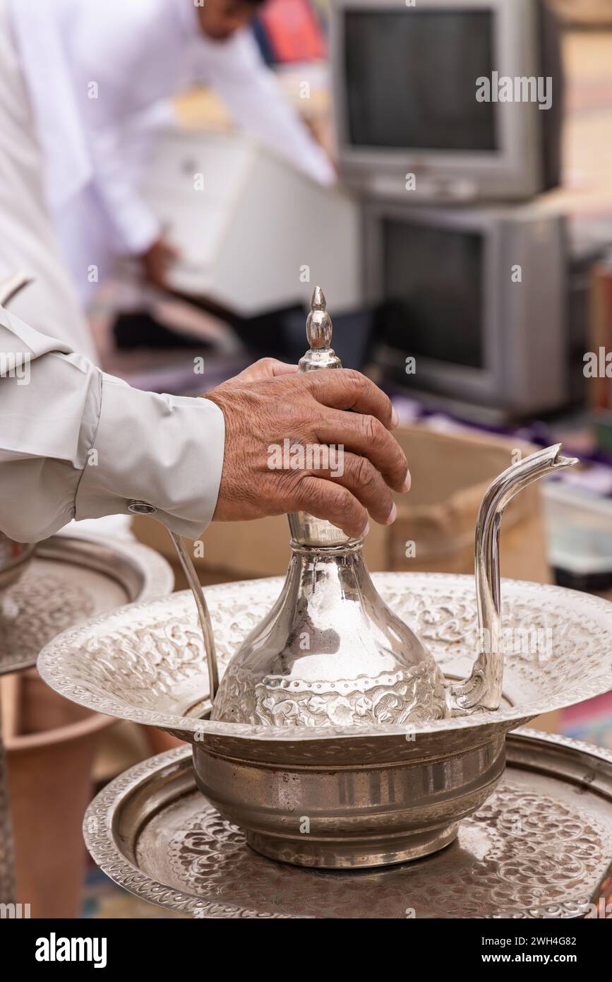 Middle East, Saudi Arabia, Riyadh, Al-Dirah. . Man holding a silver tea ...