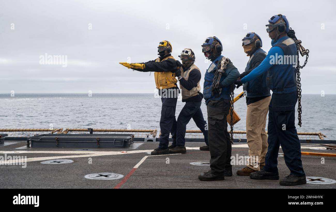 U.S. Sailors assigned to the amphibious dock landing ship USS Harpers ...