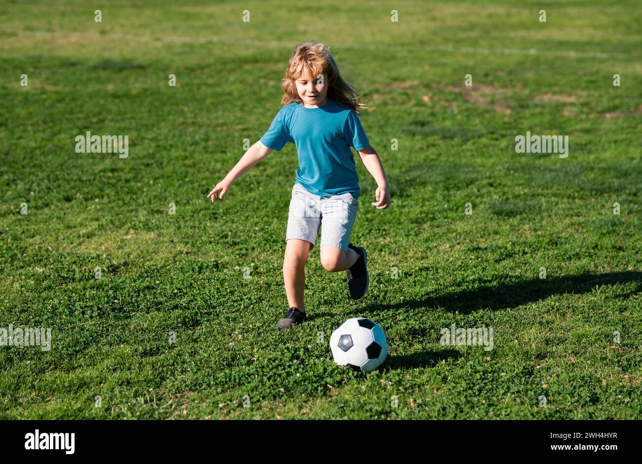 Soccer kid boy playing football. Child boy play football on outdoor ...