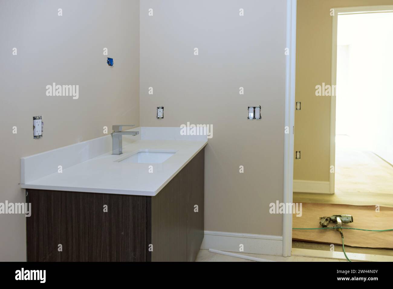 At bathroom, installation of wash basins, cabinet with drawers, white ...