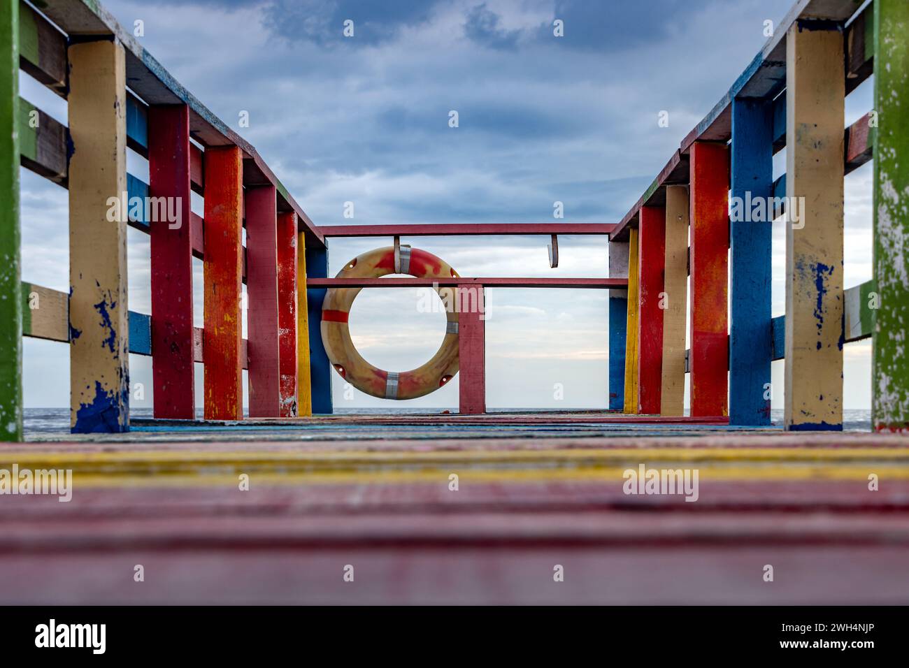The end of the colorful footbridge with a dramatic sky Stock Photo - Alamy