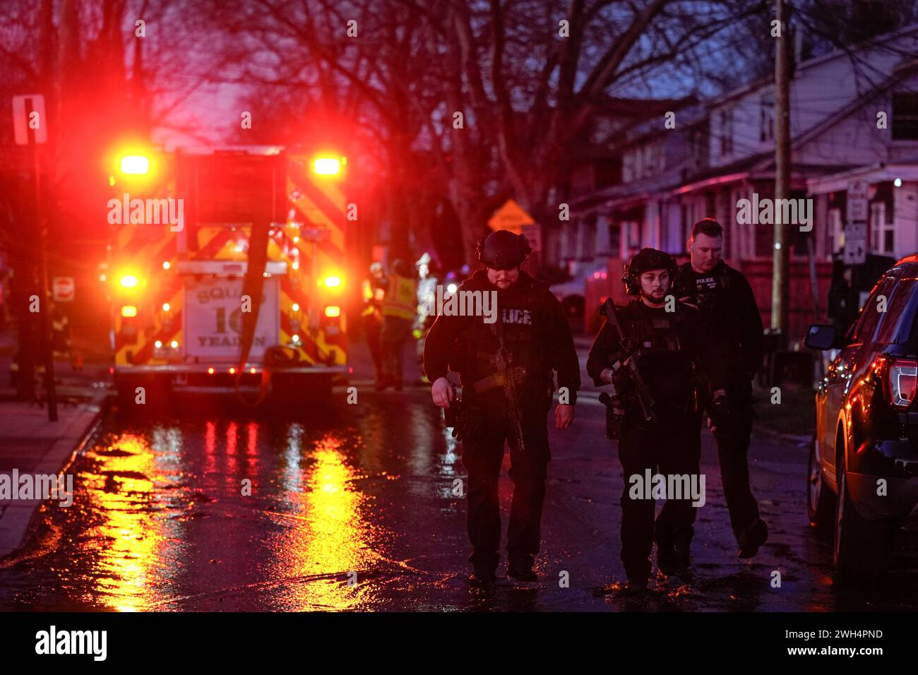 Police walk away from the scene where two officers were injured while ...