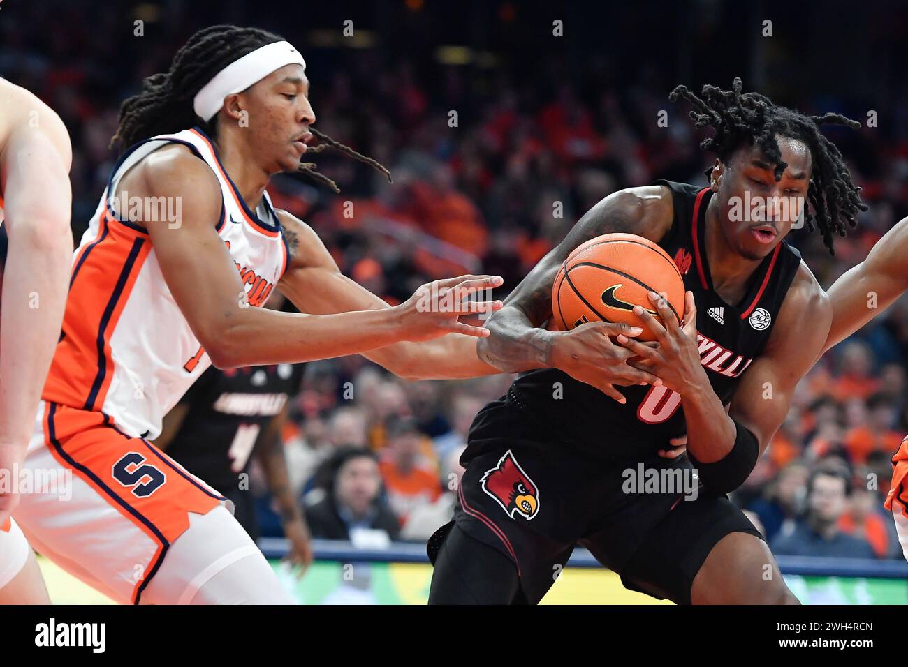 Louisville guard/forward Mike James, right, fights for a rebound ...
