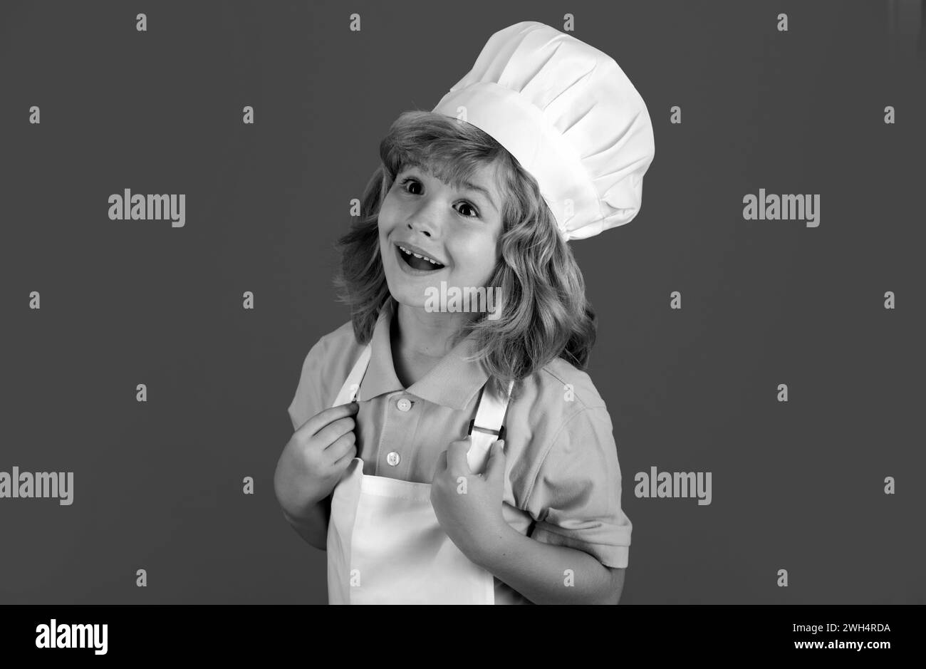 Child chef isolated on blue. Portrait of funny little kid chef cook ...