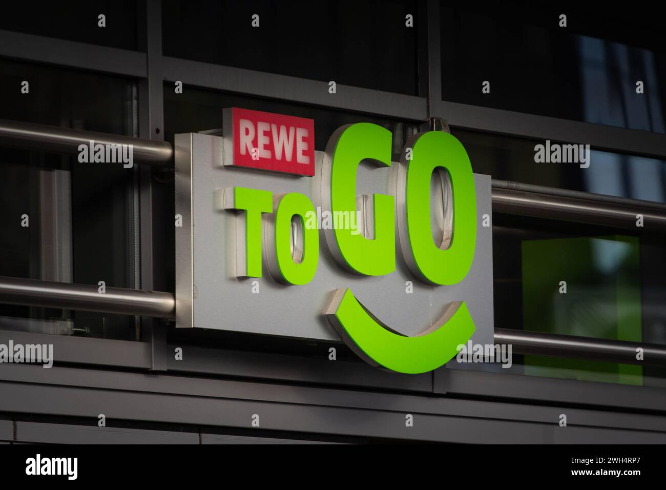 Picture of a sign with the logo of Rewe on their main store in Cologne ...