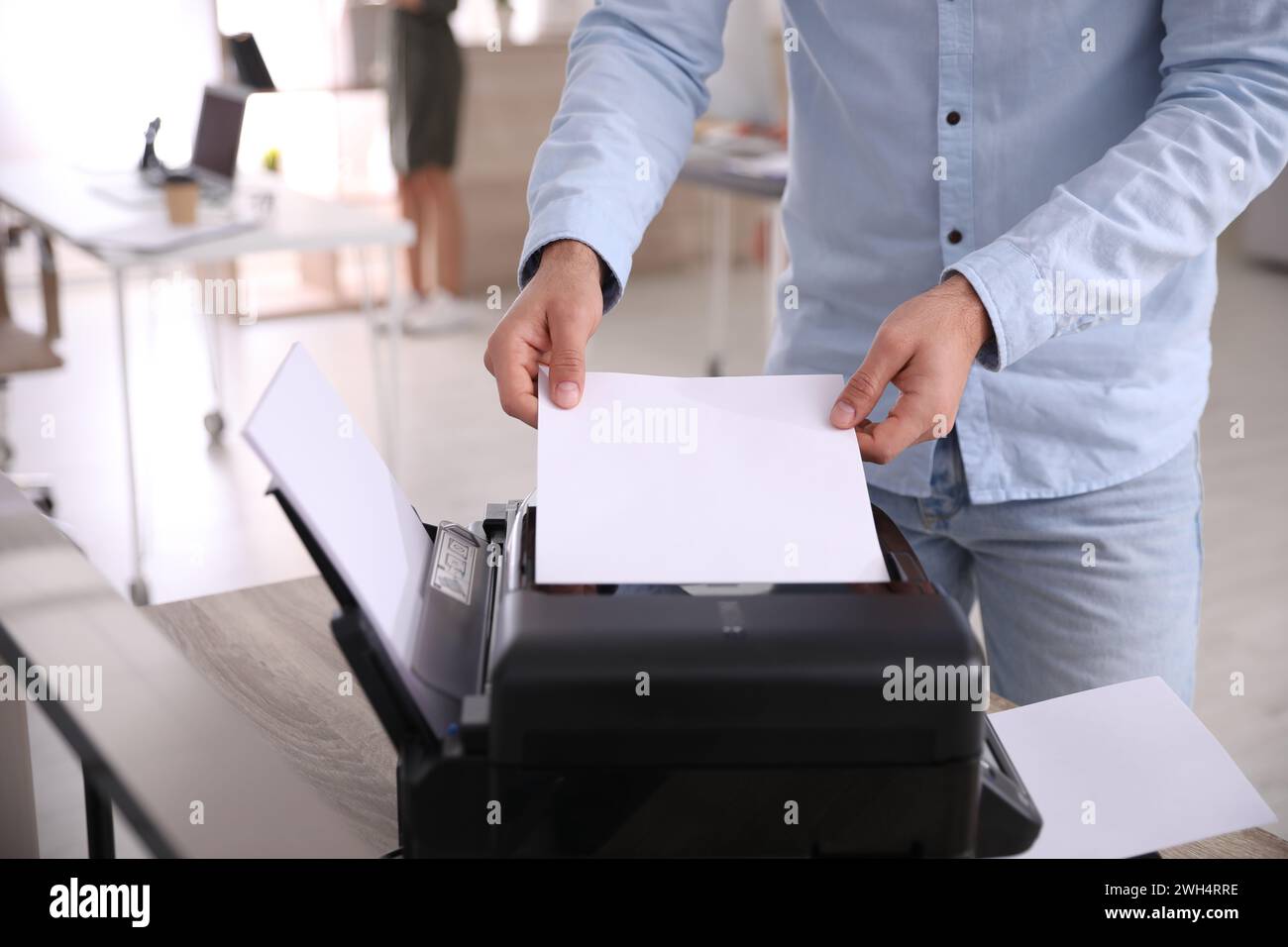 Employee using modern printer in office, closeup Stock Photo - Alamy