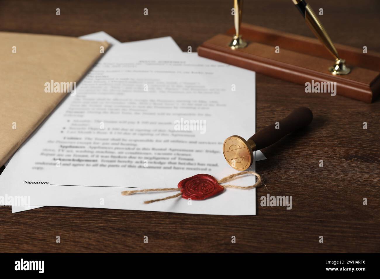Documents and stamp on wooden table. Notary contract Stock Photo - Alamy
