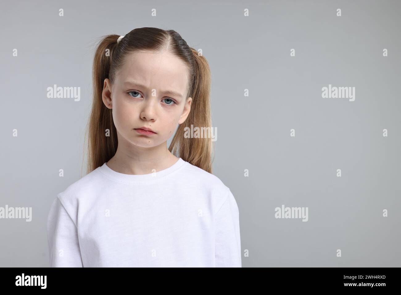 Portrait of sad girl on light grey background, space for text Stock ...