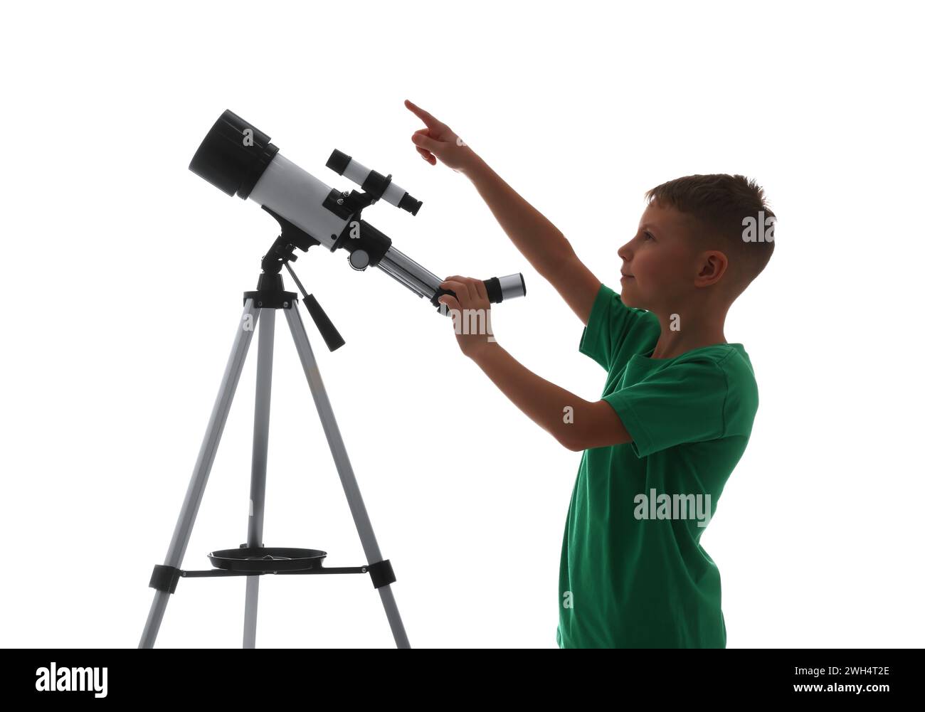 Cute little boy with telescope pointing at something on white ...