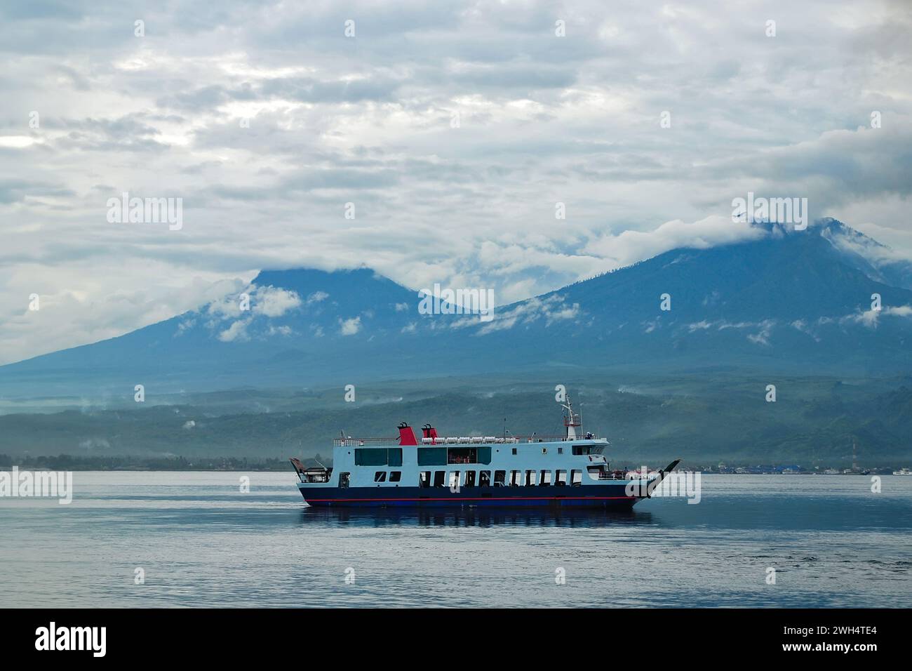 Passenger ship or ferry is sailing across the strait of Bali, Indonesia ...