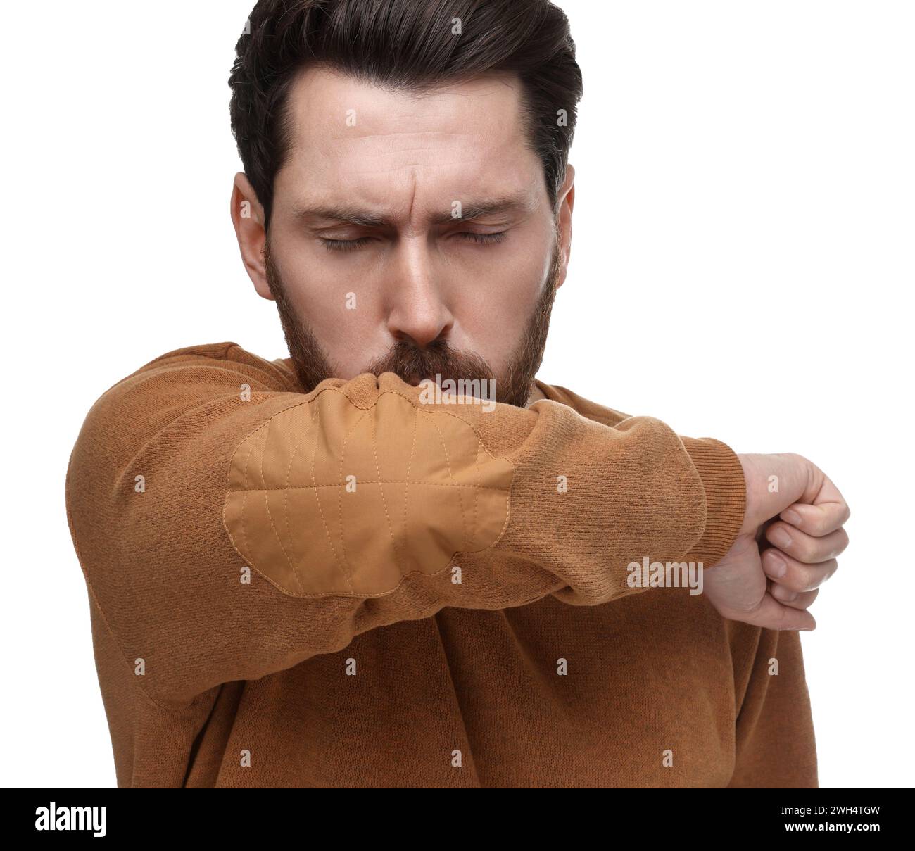 Sick man coughing into his elbow on white background. Cold symptoms ...