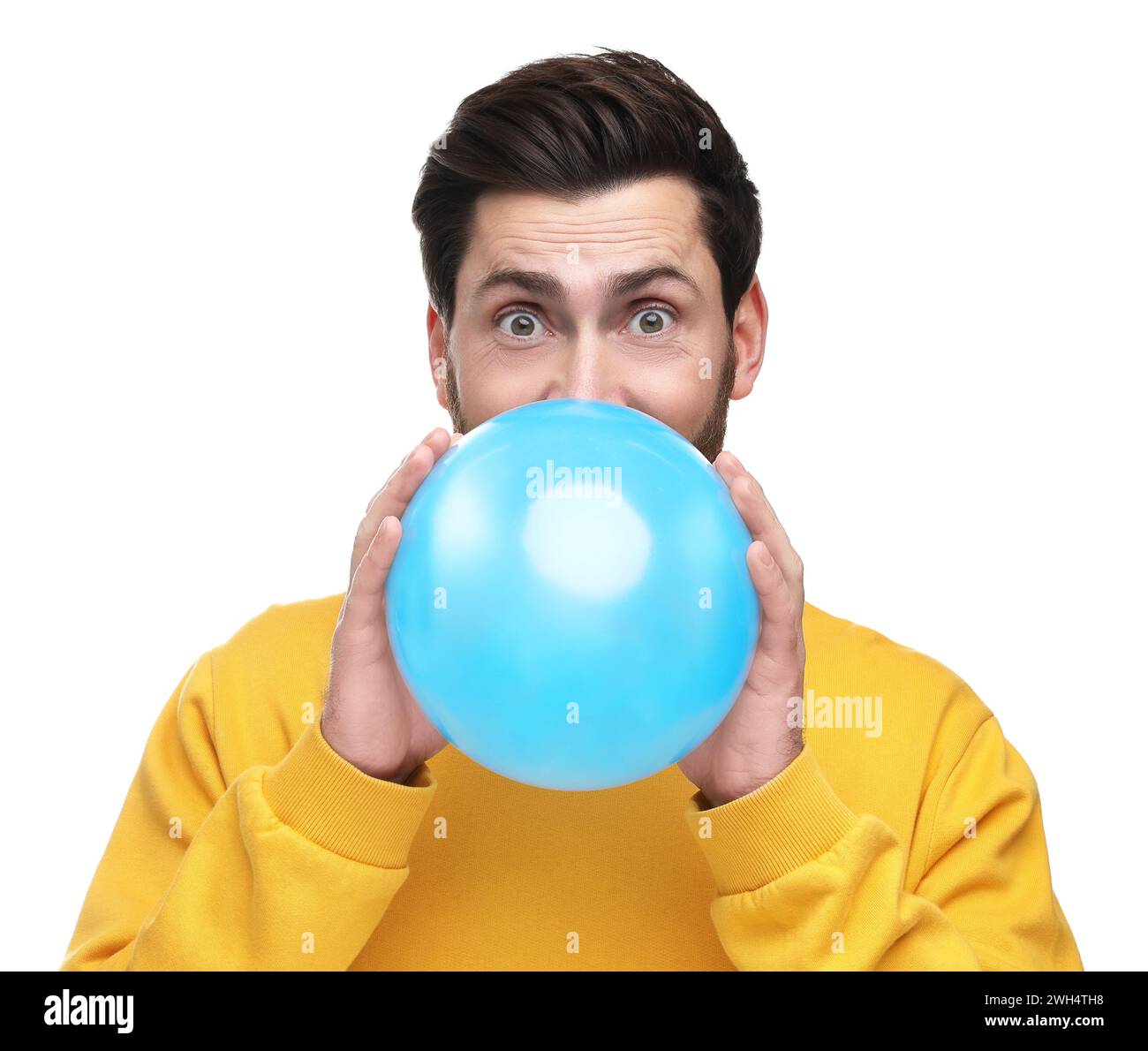 Man inflating light blue balloon on white background Stock Photo - Alamy