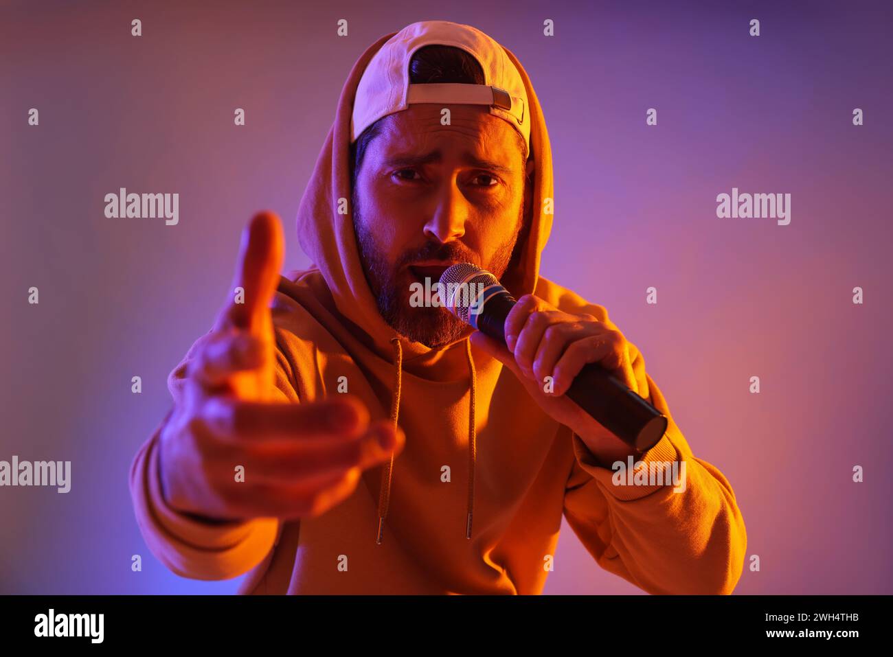 Singer with microphone rapping in color lights Stock Photo - Alamy Singer with microphone rapping in color lights Stock Photo - Alamy
