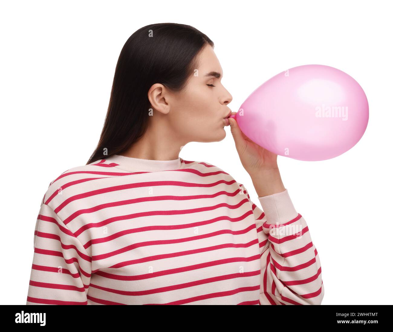 Young woman blowing pink balloon hi-res stock photography and images ...