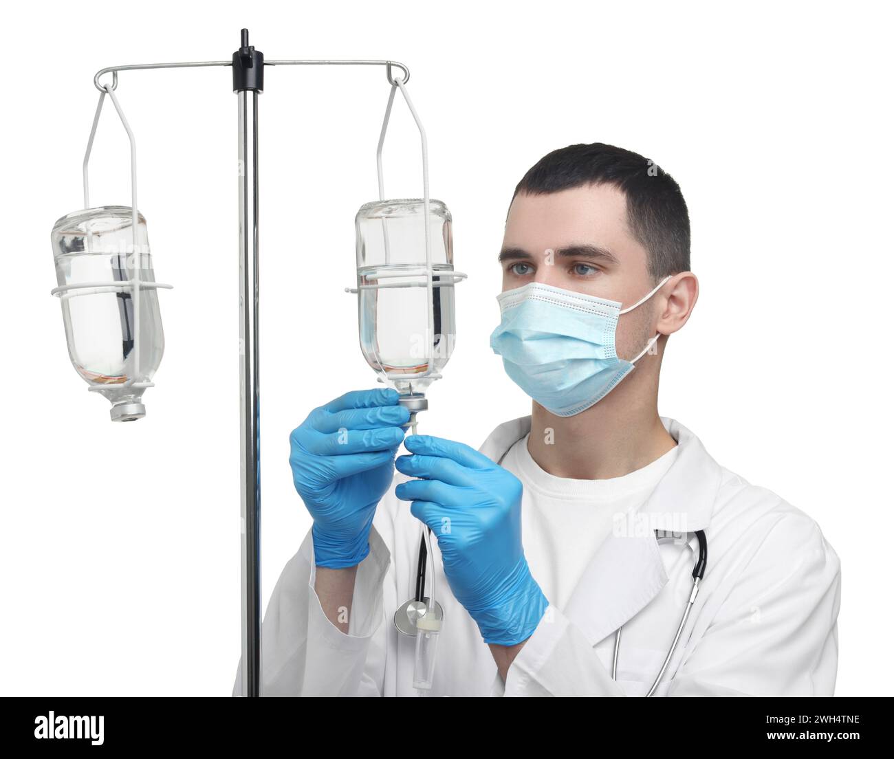 Doctor setting up IV drip on white background Stock Photo - Alamy