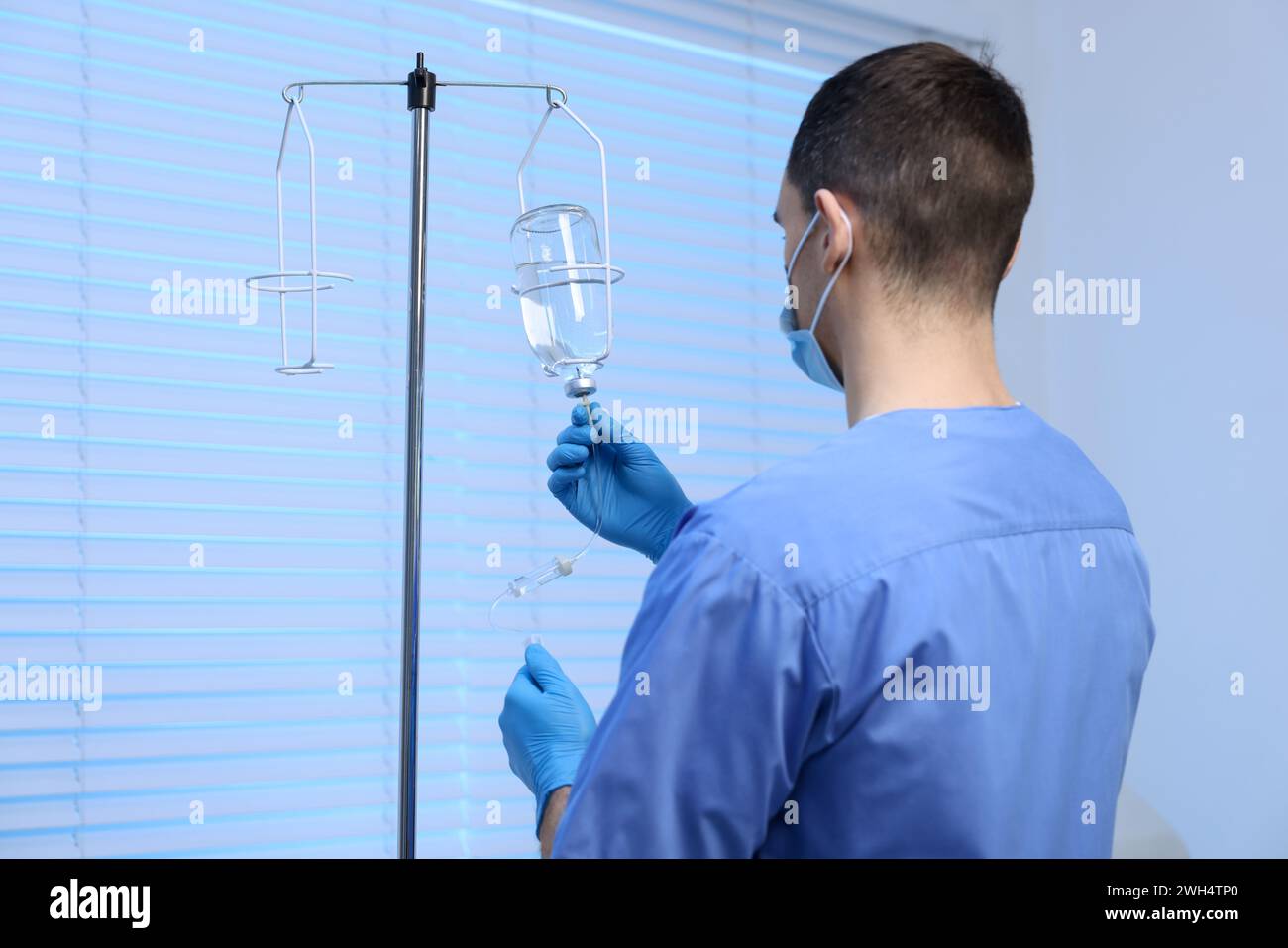 Nurse setting up IV drip in hospital Stock Photo - Alamy