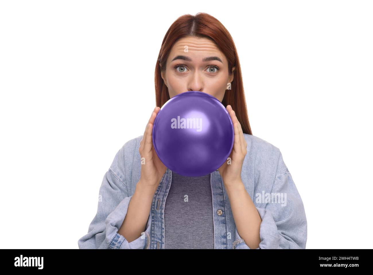 Woman inflating purple balloon on white background Stock Photo - Alamy