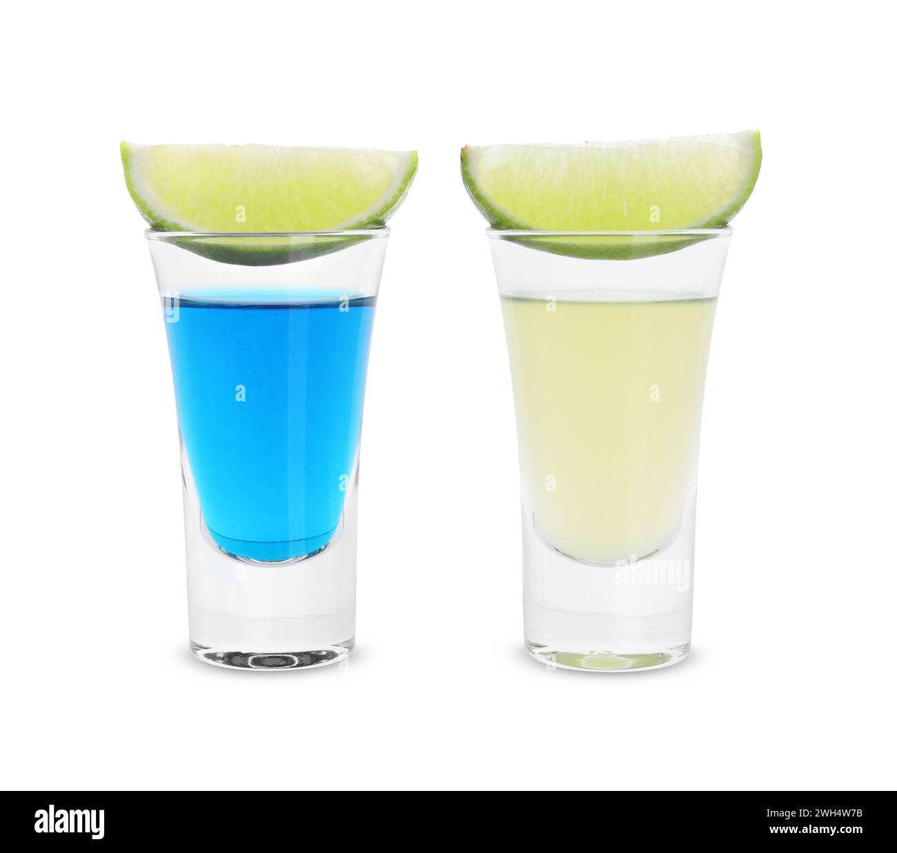 Different shooters in shot glasses and lime wedges isolated on white ...