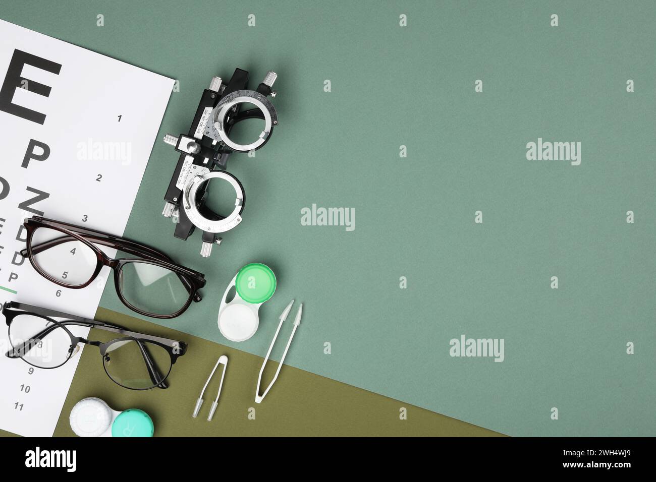 Flat lay composition with vision test chart and glasses on color ...