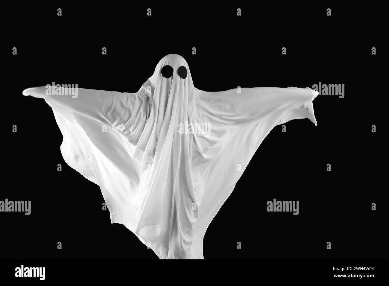 Creepy ghost. Person covered with white sheet on black background Stock ...