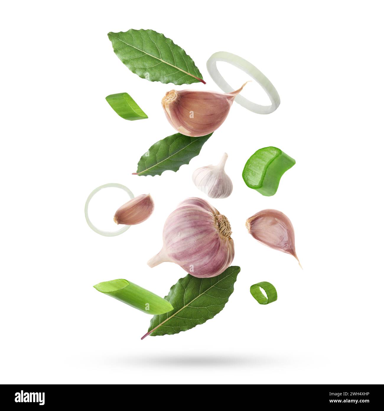 Different aromatic spices falling on white background Stock Photo - Alamy