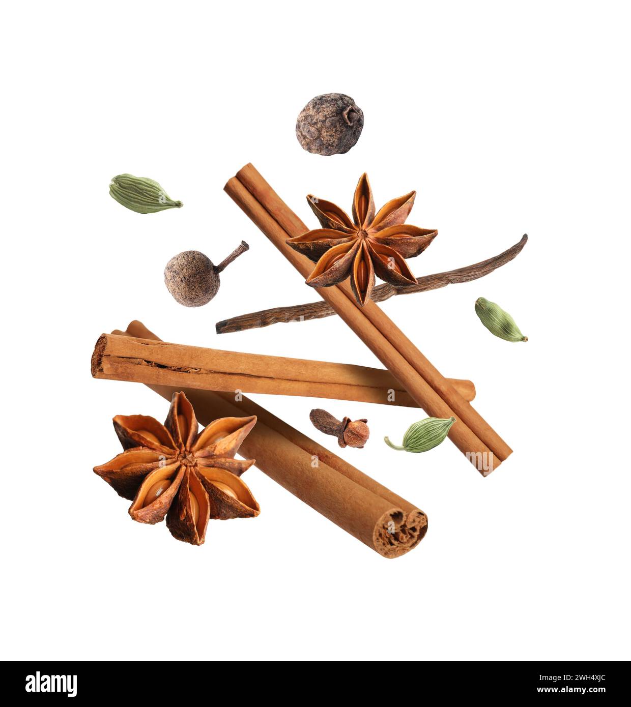 Different aromatic spices falling on white background Stock Photo - Alamy