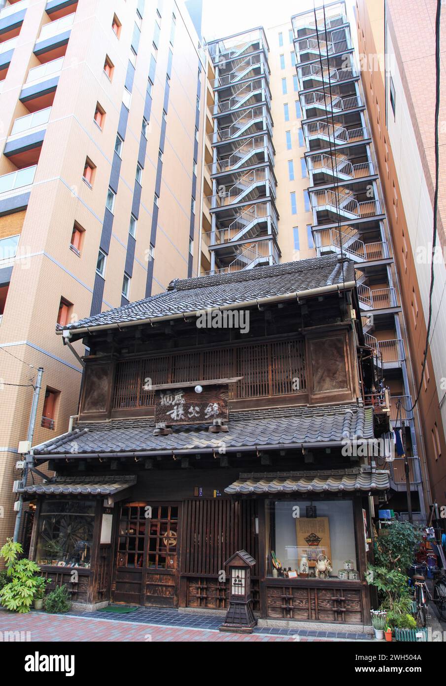 Very old building in front of tall modern apartments in Gina, Tokyo ...